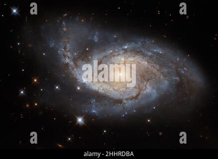 The spiral arms of the galaxy NGC 3318 are lazily draped across this ...
