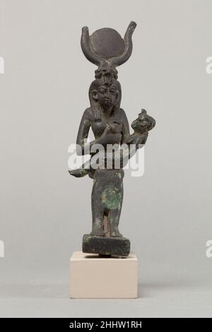 The goddess Isis, seated on a throne and holding a sceptre and ankh, in ...