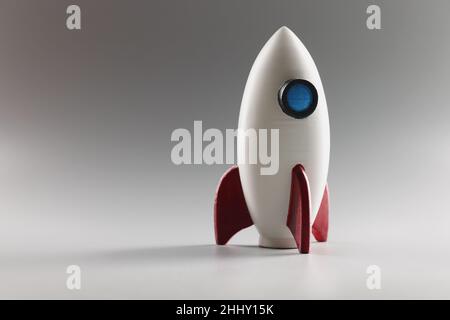 Miniature rocket toy stand on surface, rocketship as symbol for ...