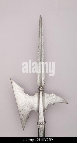This medieval halberd features a sharp blade and long wooden shaft ...
