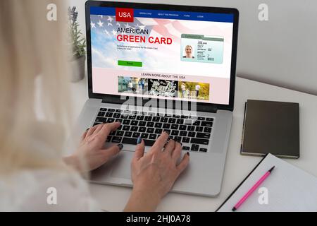 Green card in a search engine on the computer. laptop near the flag of ...