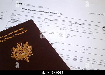 A French passport on the top of an Canadian application form to obtain ...