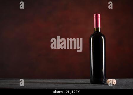 Red Wine buttle on dark background with copy space Stock Photo - Alamy