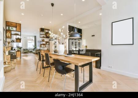 Delightful dining area with wooden table and two hanging lamps above ...