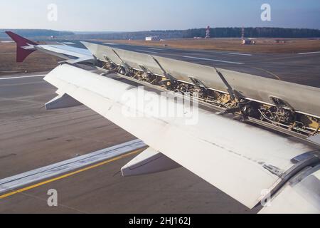 Jet plane air brakes and flaps fully extended after landing. Hydraulic ...