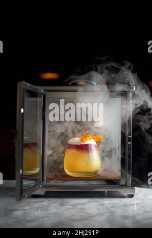 A glass of red vermouth on a marble countertop and in front of a subway ...