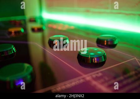 Joystick and button controls of classic arcade cabinet in dark arcade ...