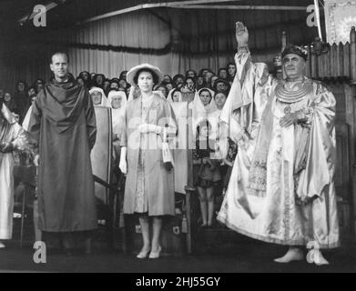 The Duke of Edinburgh, wearing the green robes of a bard, is given his ...