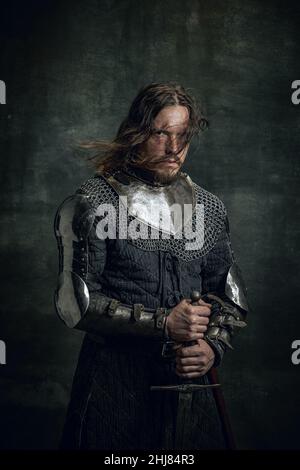 Half-length portrait of brutal seriuos man, medieval warrior or knight ...
