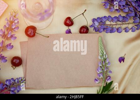 Lupins purple flowers and wine glass decorations on golden background ...