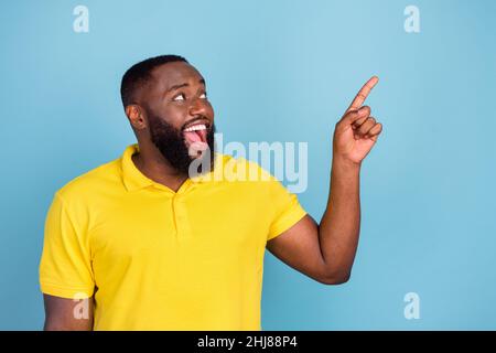 Photo of pretty shocked guy wear orange t-shirt jumping high holding ...