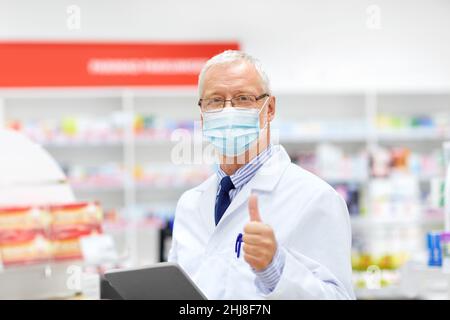 old apothecary in mask with tablet pc at pharmacy Stock Photo - Alamy