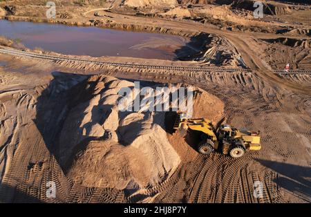Front-end loader during digging and excavation operations in open pit ...