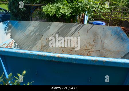 Empty waste container in a courtyard Stock Photo - Alamy