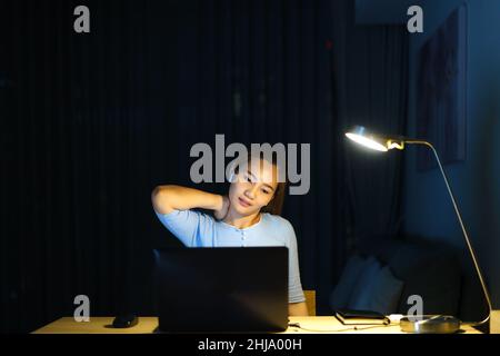 Asian woman are stretch lazily while working long hours in front of a ...