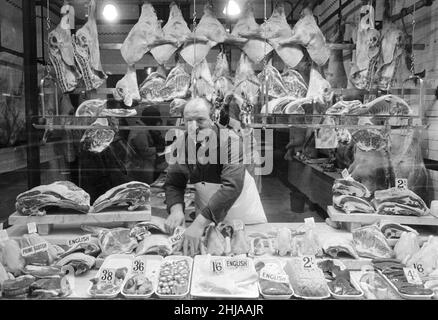Butchers shop window with various raw joints of meats on display ...