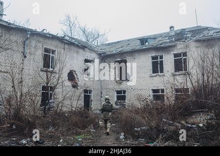 Marinka, Ukraine. 27th Feb, 2021. A soldier walks in front of a ...