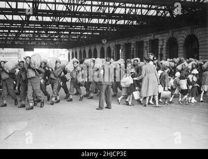 British troops arrive at the railway station while children are ...