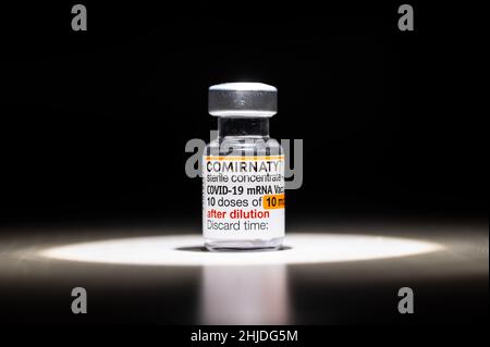 In this photo illustration a vial of COMIRNATY (Pfizer BioNTech ...