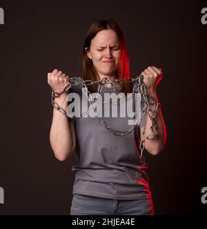 Young woman ties with chain, suffer from despair, psychological ...