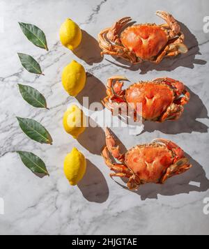 crabs and seafood. Crab boiled and lemons in ice on a yellow background ...