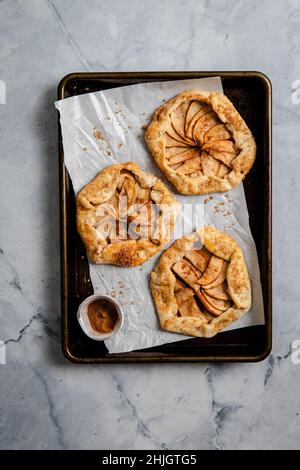 Mini apple galettes on a sheet pan Stock Photo - Alamy