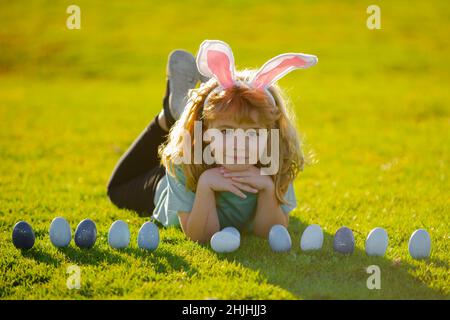 Kids boy hunting easter eggs. Children celebrating easter. Kid in ...