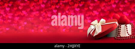 Gifts for Valentine's Day celebration and beads on color background ...