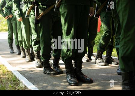 Military stands in row. Soldiers' shoes. Boots and military uniforms ...