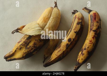 Twin Ripe plantain yellow in colour, ready to eat with skin half peeled ...