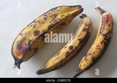 Twin Ripe plantain yellow in colour, ready to eat with skin half peeled ...