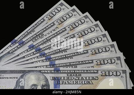 US 100 dollar notes fanned out on black background Stock Photo - Alamy