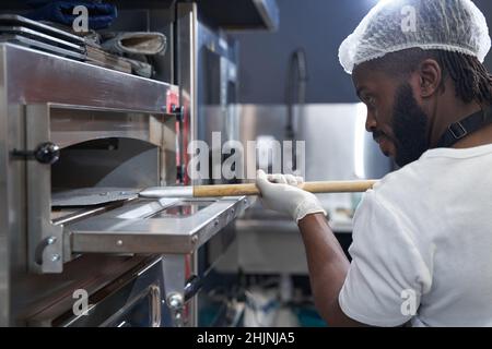 American chef hard working, baking food in restaurant Stock Photo - Alamy