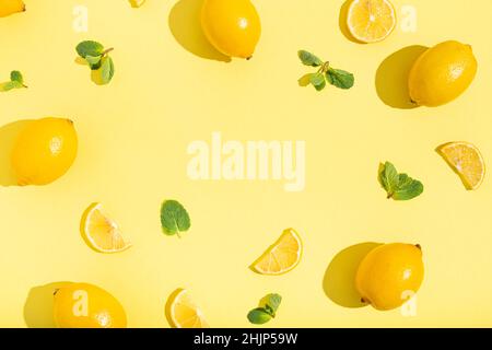 Lemons with mint on minimal beige yellow background on bright sun light ...