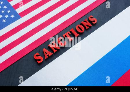 Word SANCTIONS on USA flag Stock Photo - Alamy