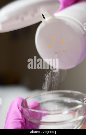 Woman's Hand Using Talcum Powder On Grey Background Stock Photo - Alamy