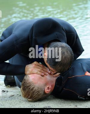 Lesson of artificial respiration. Lifeguard giving drowning mouth-to ...