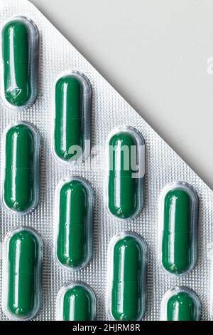 Pack of green capsule pills, close-up photo, top view Stock Photo - Alamy