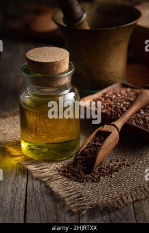 Flaxseeds and linseed oil. Linseed oil with kitchen utensils on an old ...
