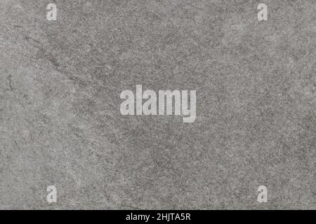 Gray stone tile wall surface with subtle linear patterns and geometric ...
