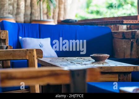 Wooden tables in cafe. Authentic interior of restaurant in Kendwa ...