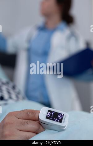 Physician measuring the oxygen saturation and pulse rate using an ...