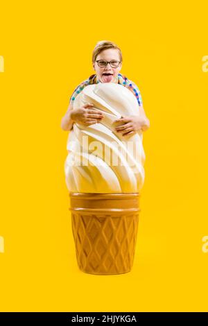 A cute boy hugs a huge ice cream. Confectionery. Delicious dessert ...