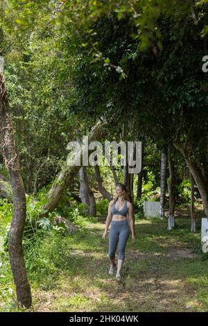 Happy oung woman exercising at a park on a beautiful sunny day. Woman ...