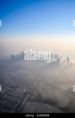 Doha skyline at sunrise with morning fog Stock Photo - Alamy