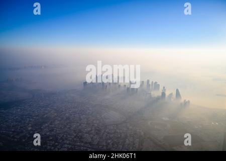 Doha skyline at sunrise with morning fog Stock Photo - Alamy