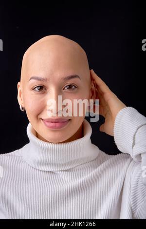 Emotional portrait of woman, shaved bald, in a light shirt with a tie ...