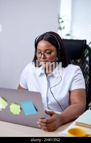 Young female technical support dispatcher working in office Stock Photo ...