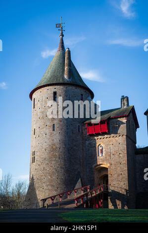 Cardiff Castle, view of a tower and red dragon flag from outside castle ...