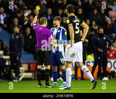 Referee Andrew Kitchen gives yellow card to Callum Lang #19 of Wigan ...